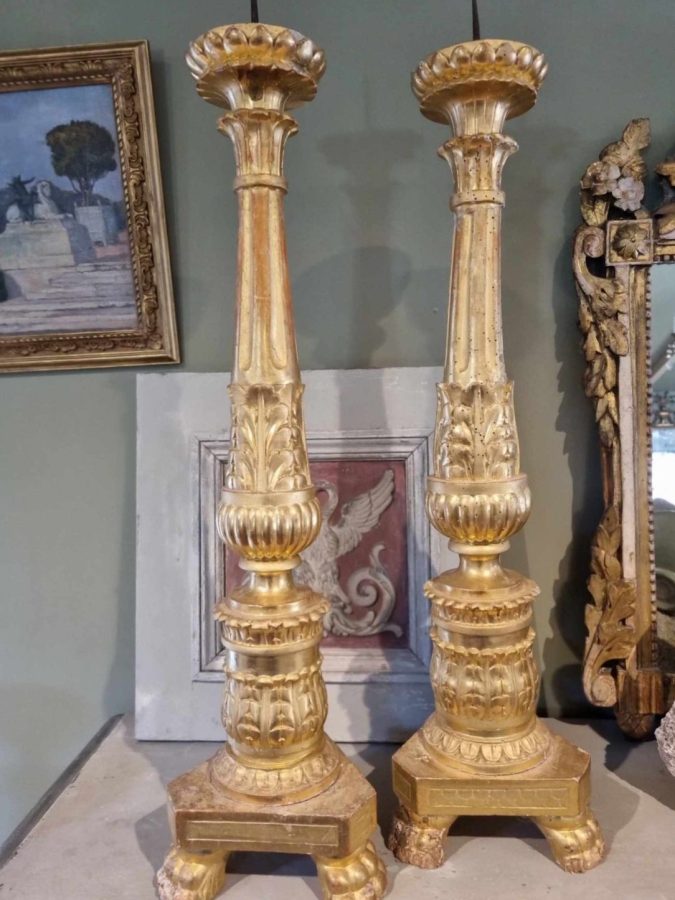 An elaborately carved, near pair of candlesticks. Slightly different ...